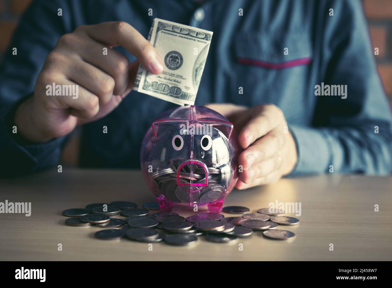 Men are using banknotes in the piggy bank with the idea of collecting ...