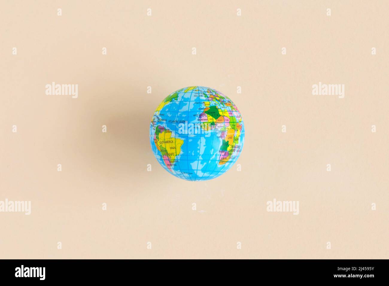 Earth globe on isolated beige pastel background. Civilization. Top view ...