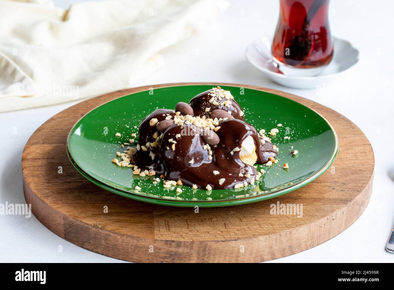 Profiterole on a white background. Profiterole filled with milk cream ...