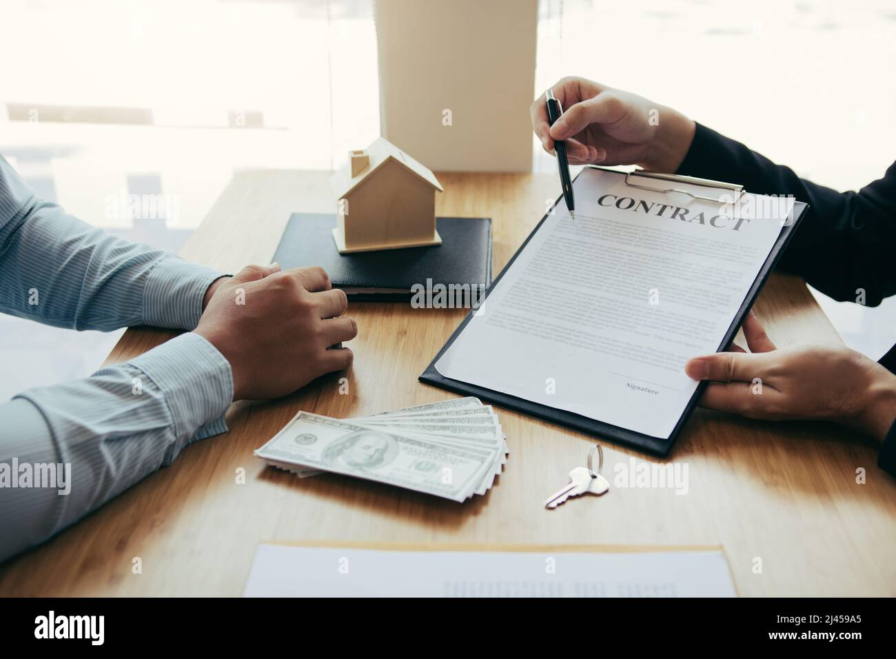 Agents are using pens pointing to insurance contracts and are being ...
