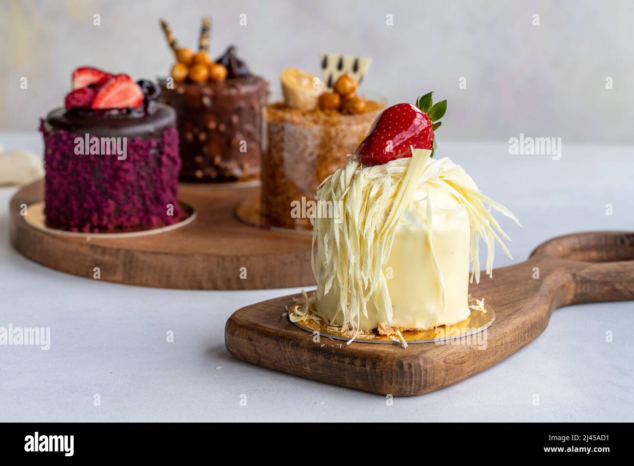 Types of cakes. Varieties of small cakes on a white background. Bakery ...