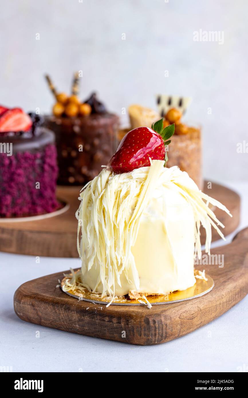 Types of cakes. Varieties of small cakes on a white background. Bakery ...