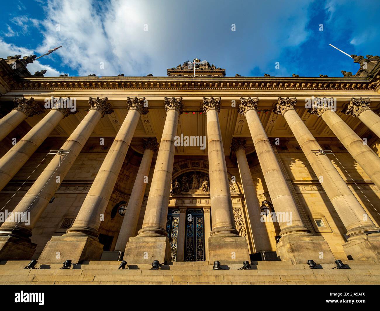 Corinthian columns of the portico at the entrance to Leeds Town Hall looking upward toward a ...