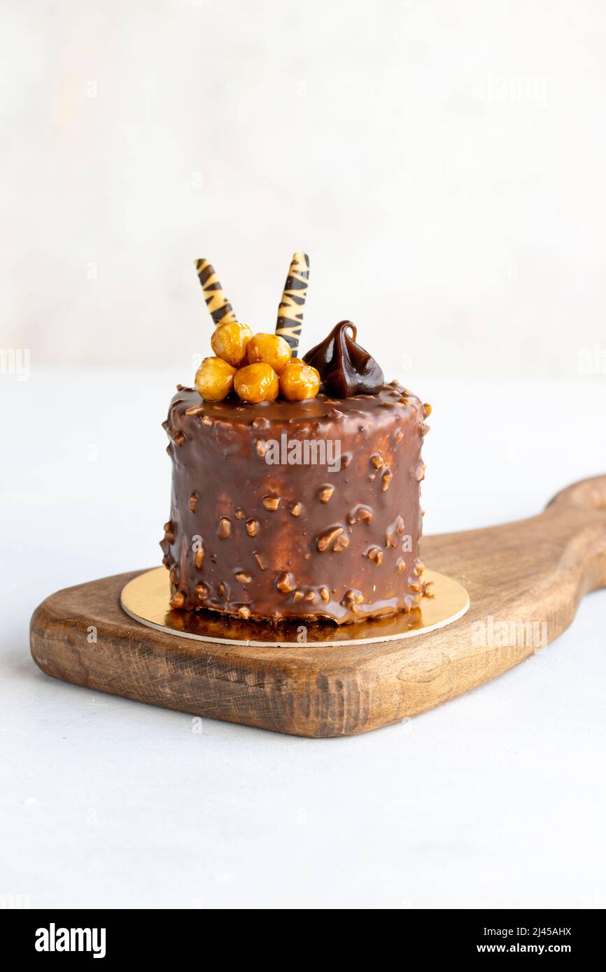 Chocolate cake on a white background. Cake with croquant and cream ...