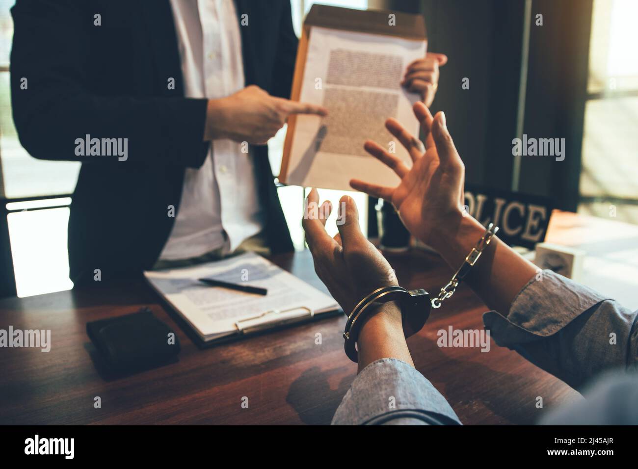 The police officer pointed to the document requesting the arrest of the ...