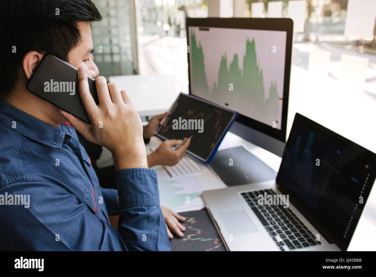 Two asian agent man working and analysis together in office market ...