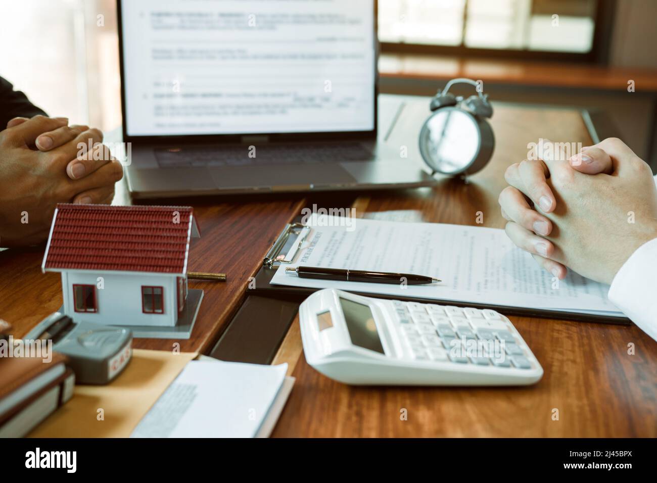 House sales representative sat at the office with the new home buyer ...
