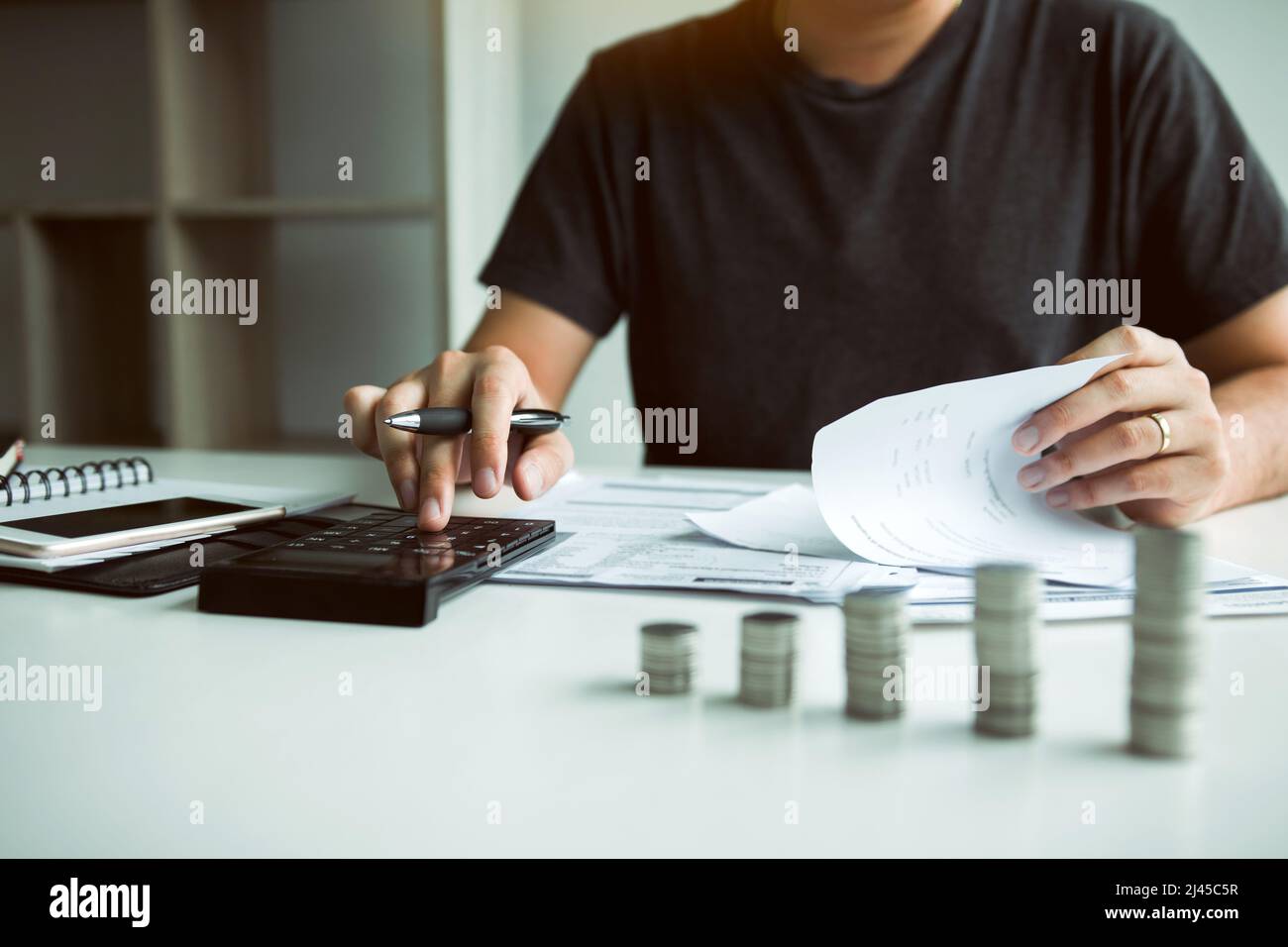 Asian men are calculating about finances about the cost or future ...