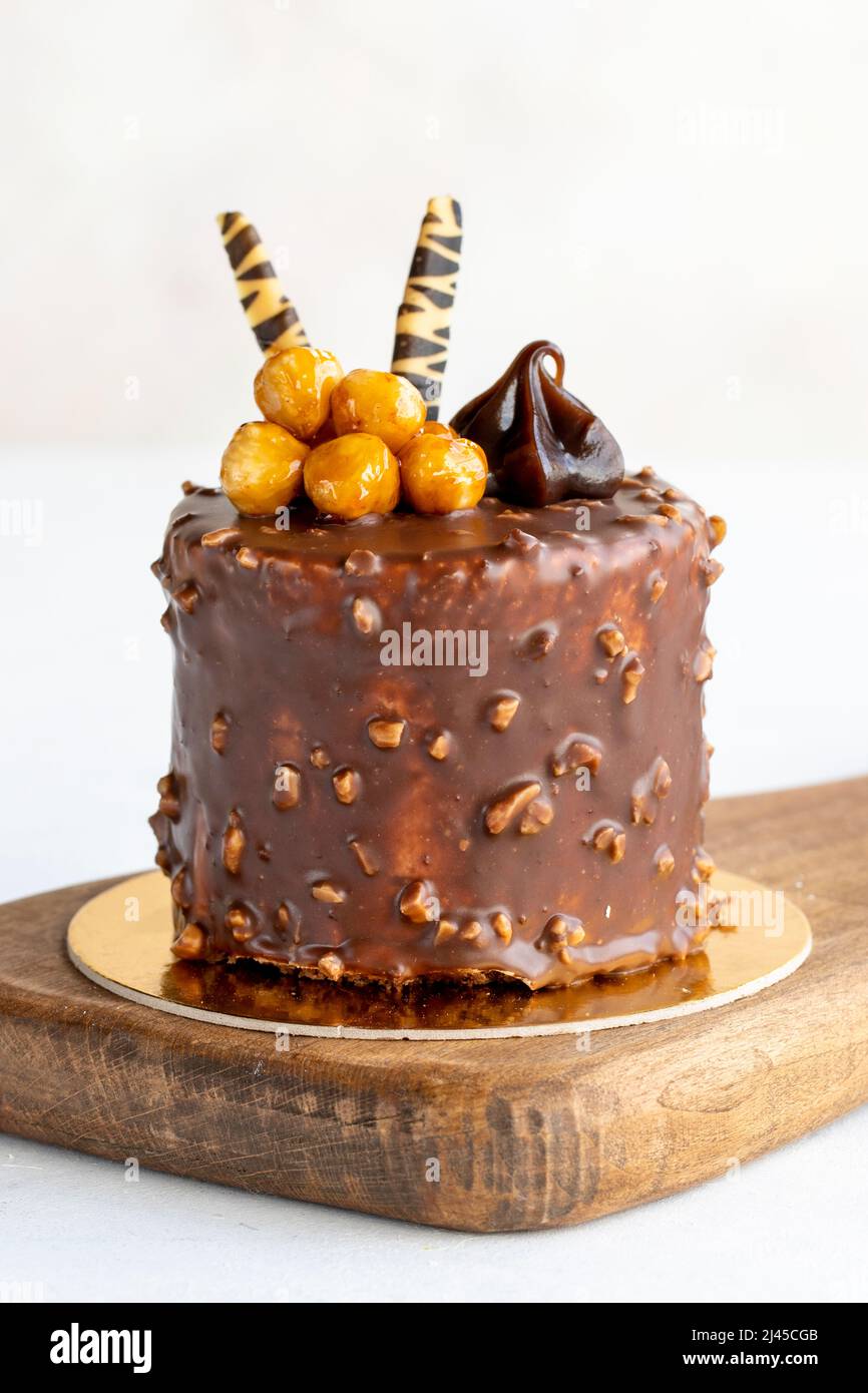 Chocolate cake on a white background. Cake with croquant and cream ...