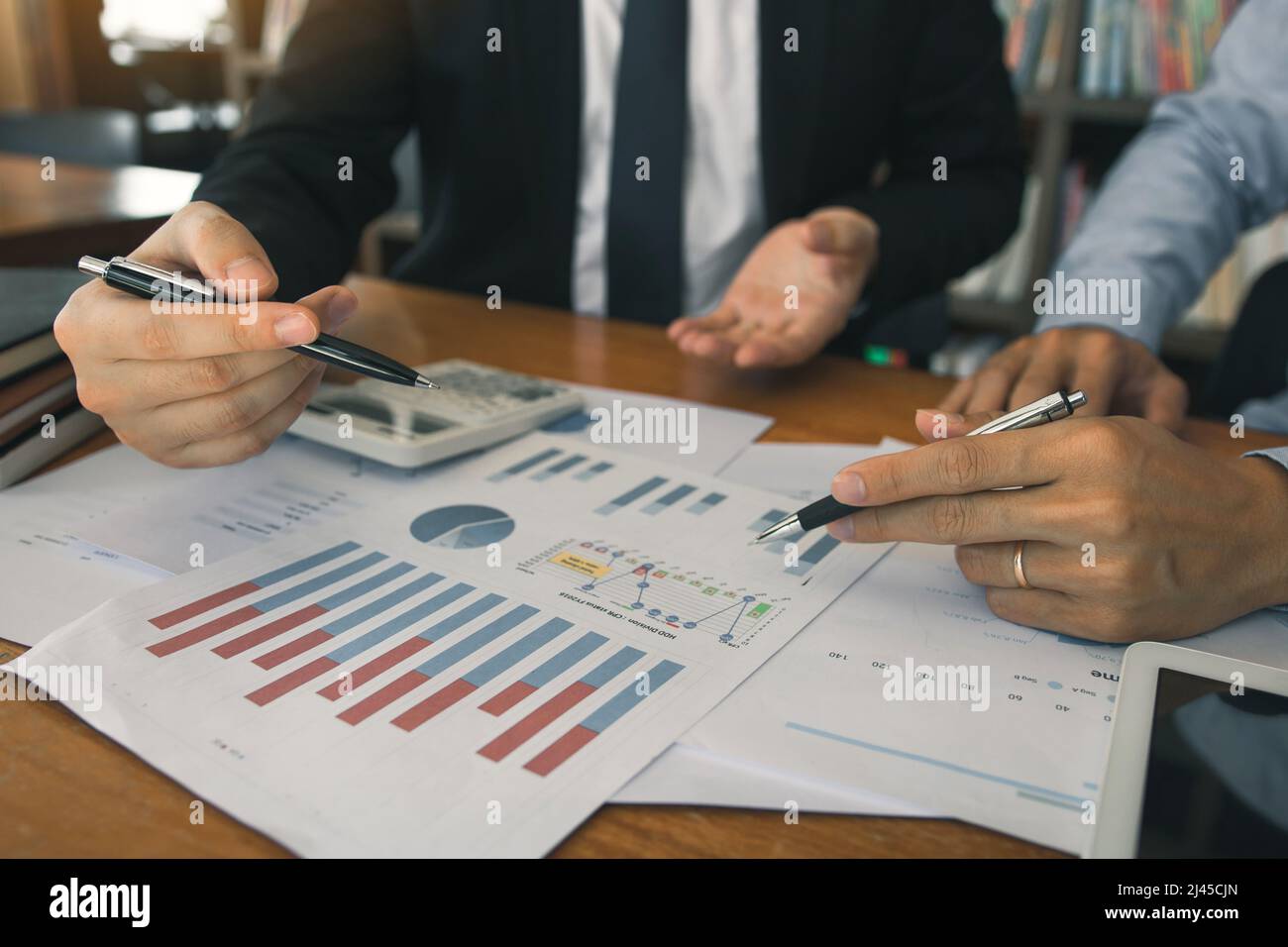 Two businessmen discussion analysis sharing calculations about the ...