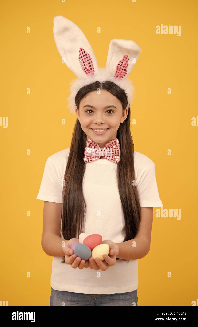 happy easter teen girl in bunny ears and bow tie hold painted eggs, easter egg Stock Photo - Alamy