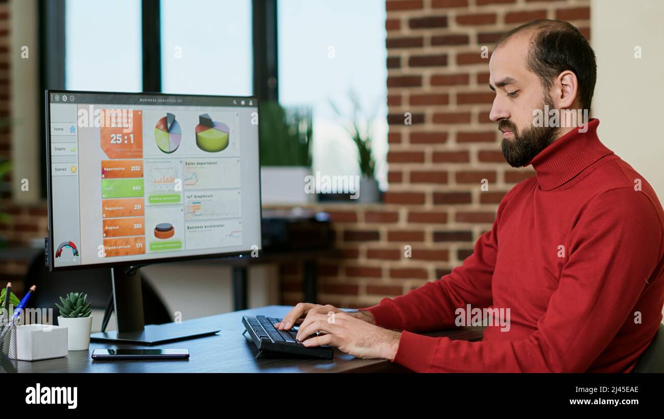 Financial analyst creating e commerce data graphs on screen, using ...