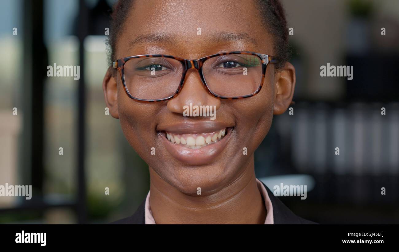 Portrait of female model smiling in front of camera, showing happy ...