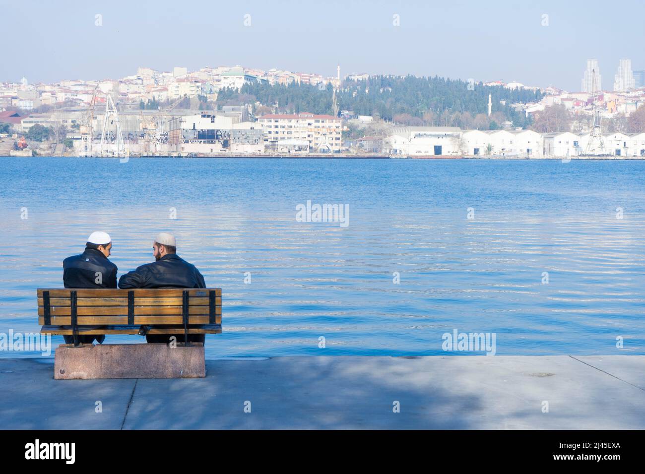 Two muslim young men chatting by the sea Stock Photo - Alamy