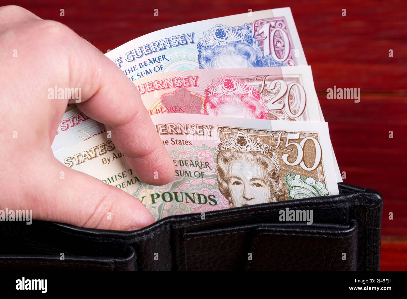 Guernsey money - pounds in the black wallet Stock Photo - Alamy