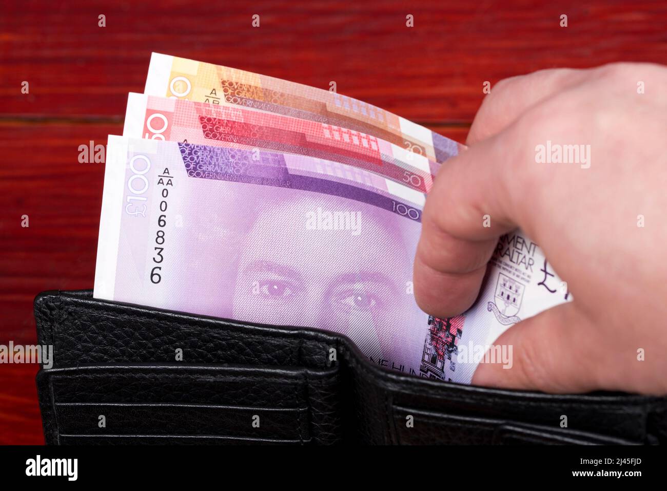 Gibraltar money - pound in the black wallet Stock Photo - Alamy