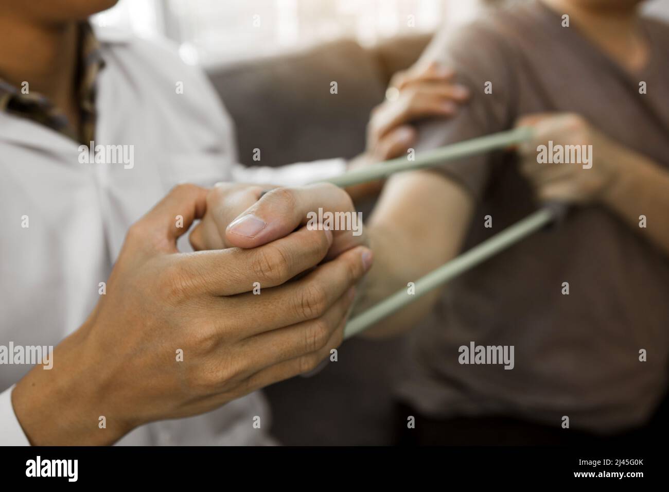Close up hand patient doing stretching exercise with a flexible ...
