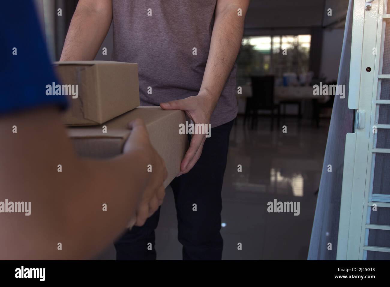 Close up of hands cargo staff are delivering cardboard boxes with ...