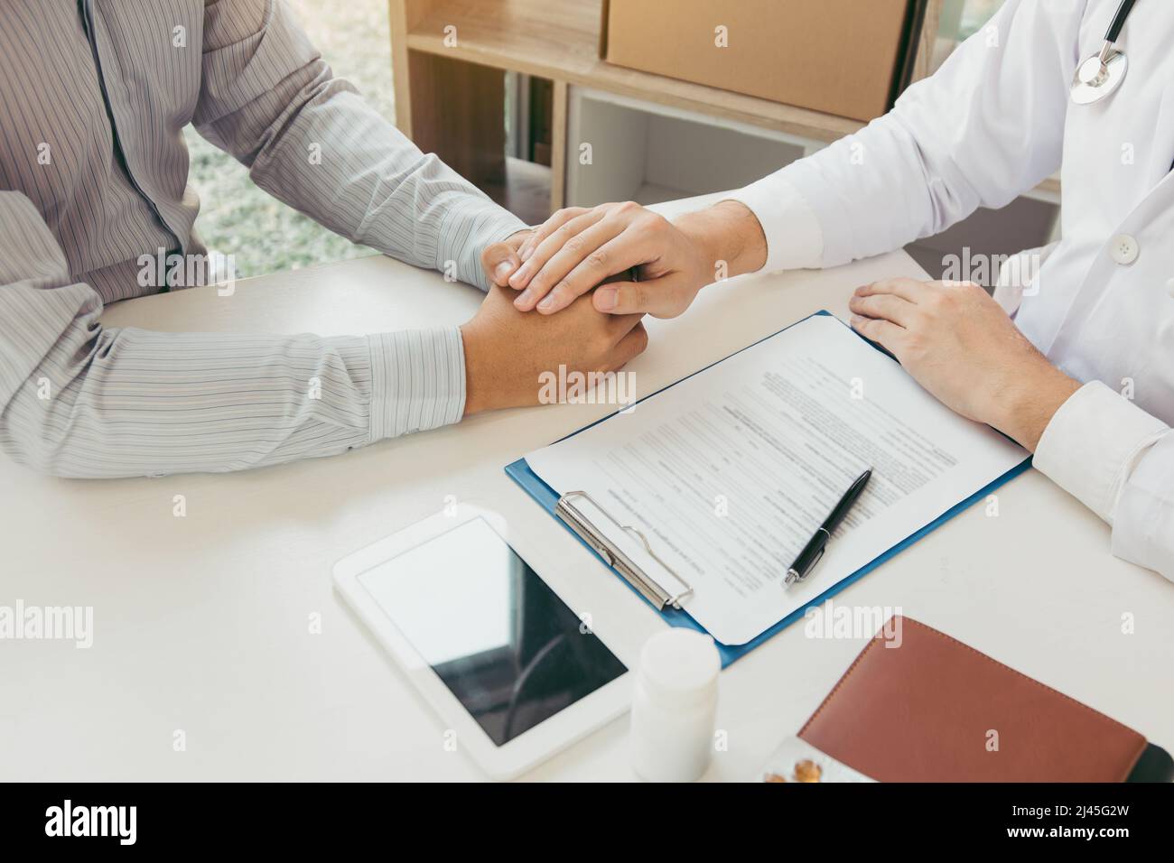 The doctor shook hands and consoled the patients who were worried about ...