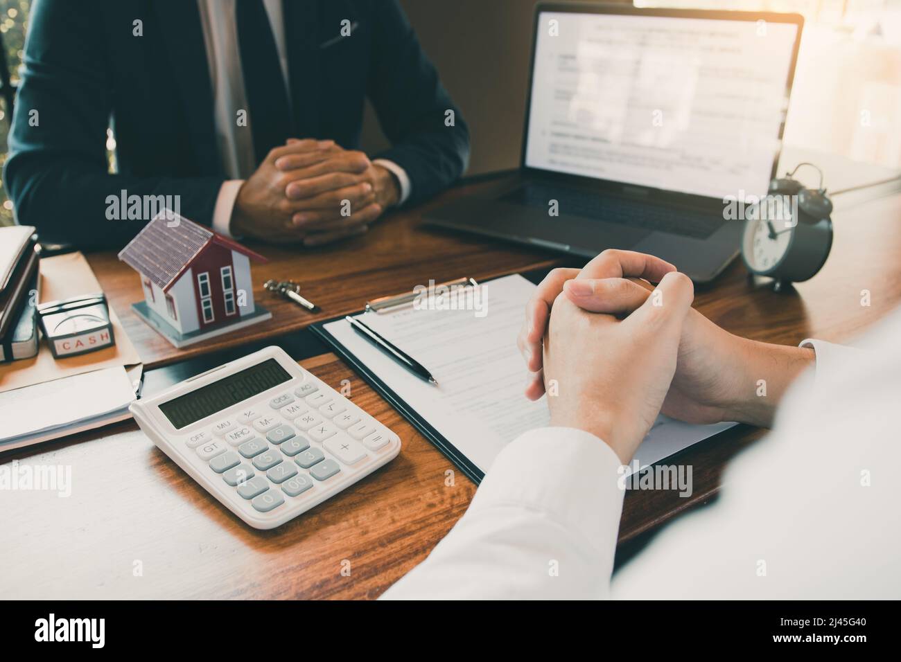 House sales representative sat at the office with the new home buyer ...