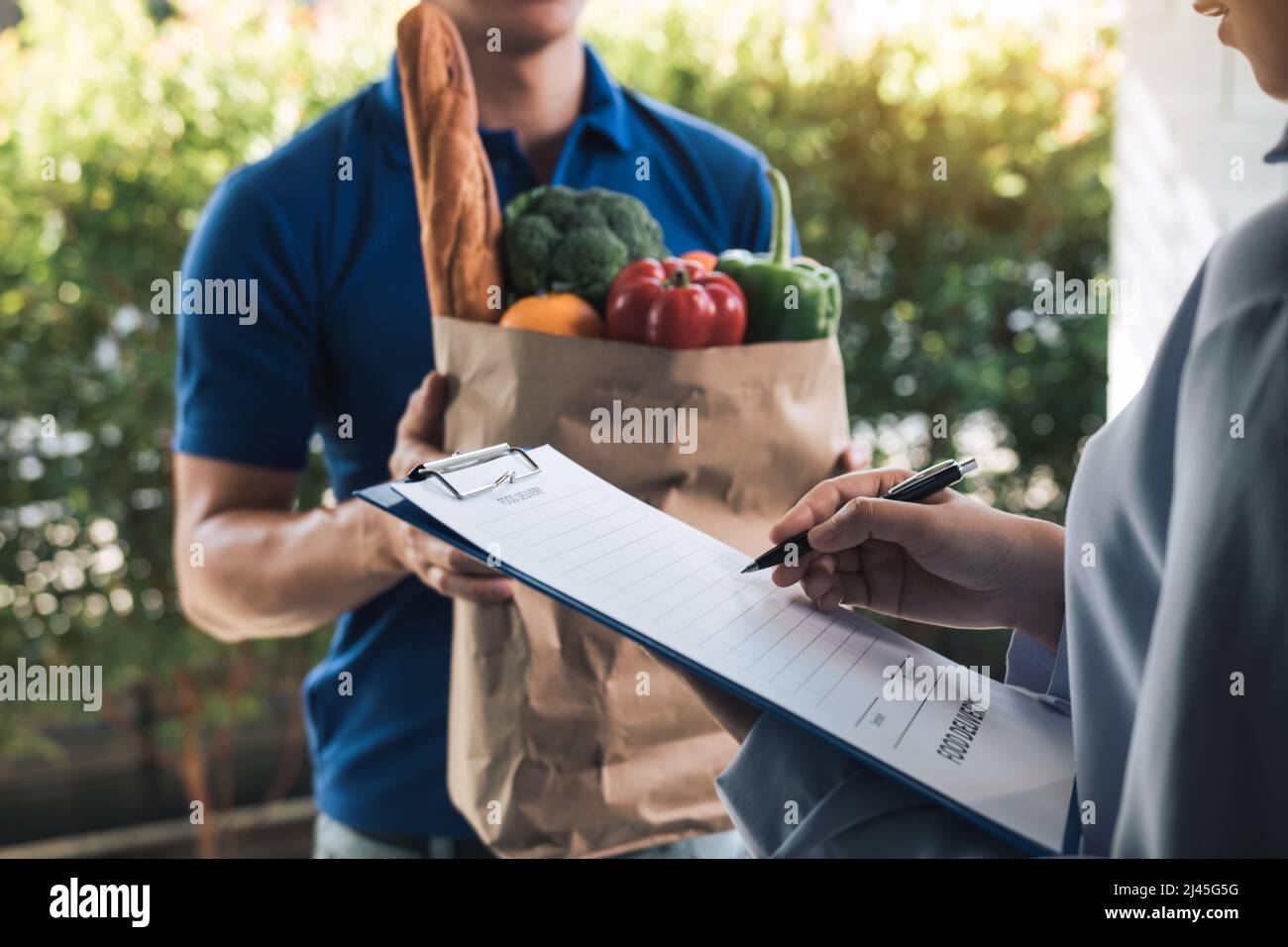 Asian woman is checking the product and signing the receipt on the ...