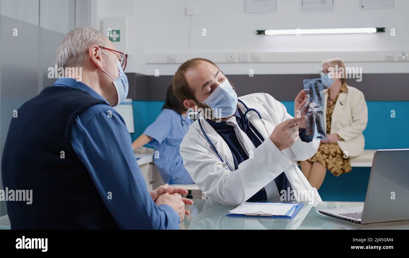 General practitioner analyzing radiography results in office ...