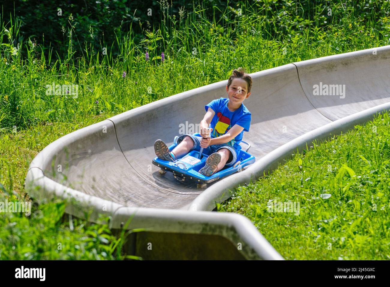 Family fun tobogganing in summer, up with the lift ... down with the ...