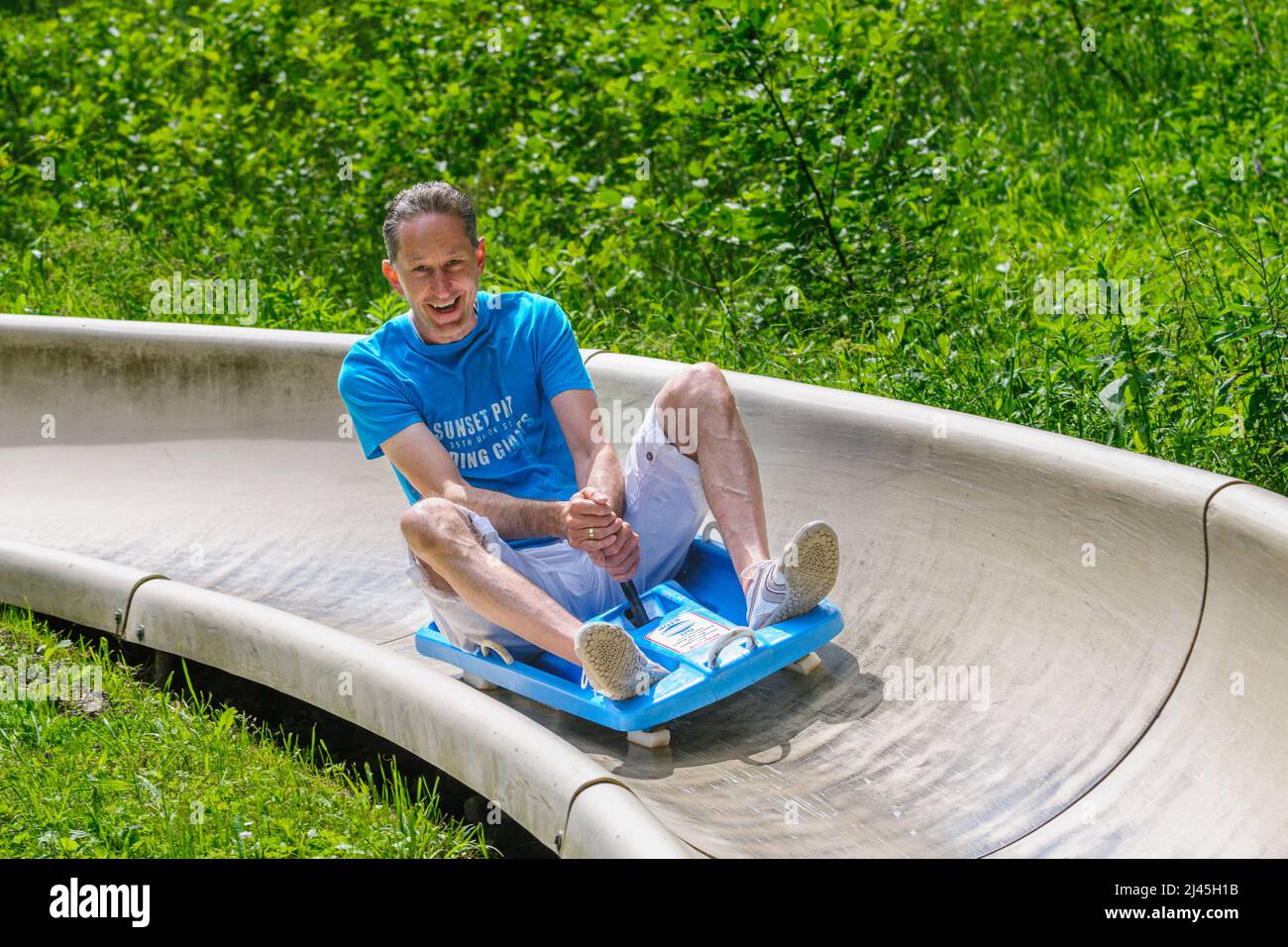 Family fun tobogganing in summer, up with the lift ... down with the ...