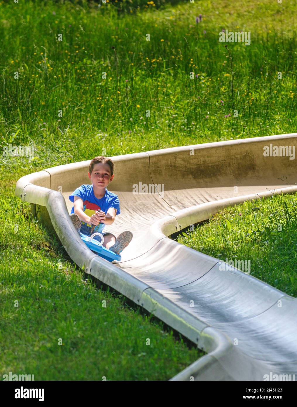 Family fun tobogganing in summer, up with the lift ... down with the ...