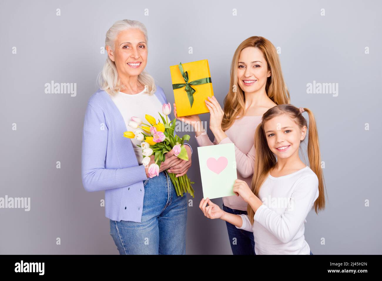 Portrait of three friendly peaceful people congratulate hold postcard ...