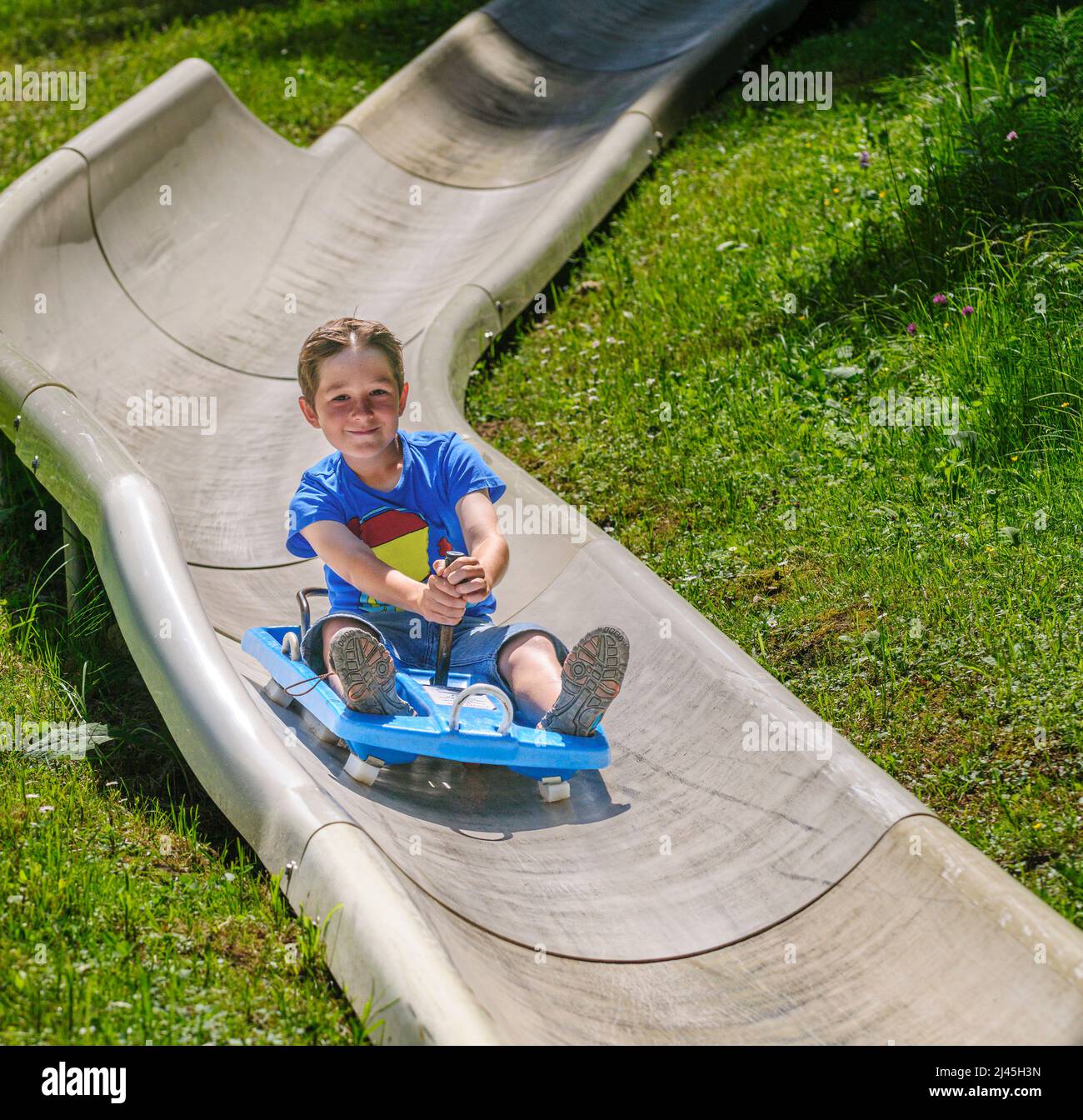 Family fun tobogganing in summer, up with the lift ... down with the ...