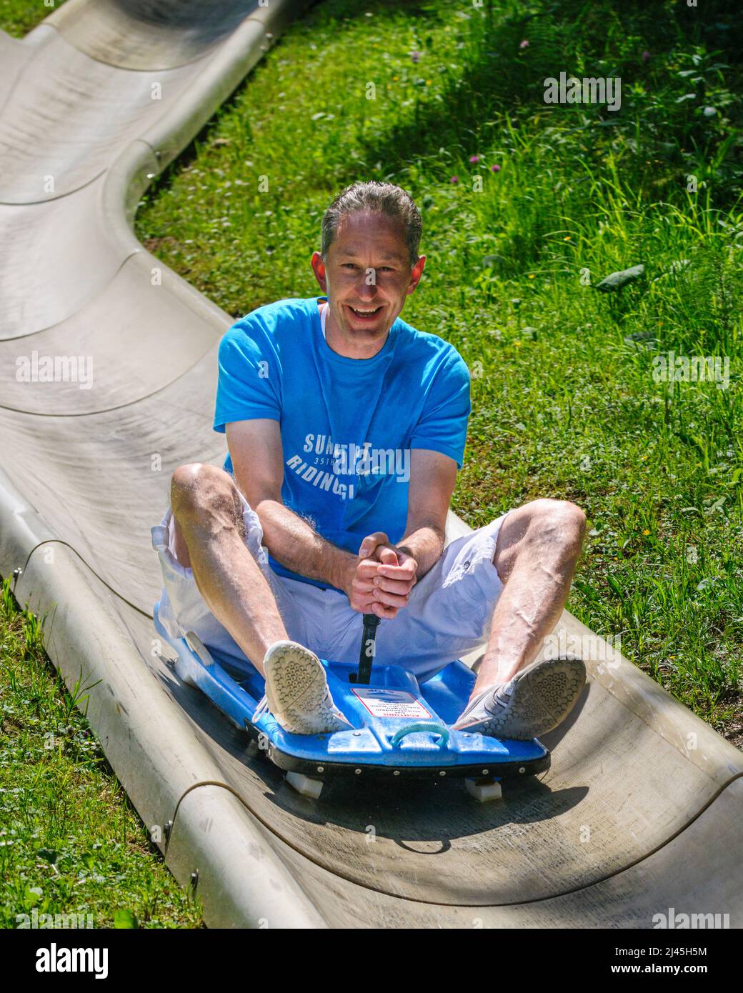 Family fun tobogganing in summer, up with the lift ... down with the ...
