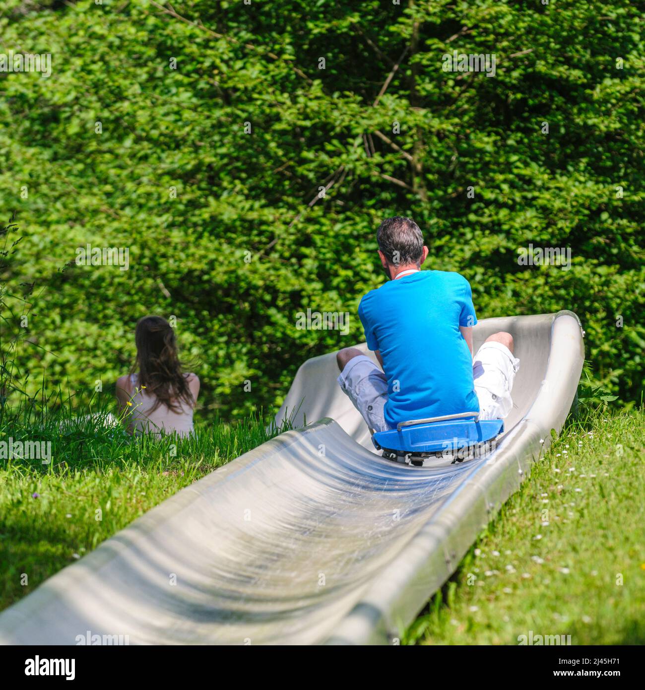 Family fun tobogganing in summer, up with the lift ... down with the ...