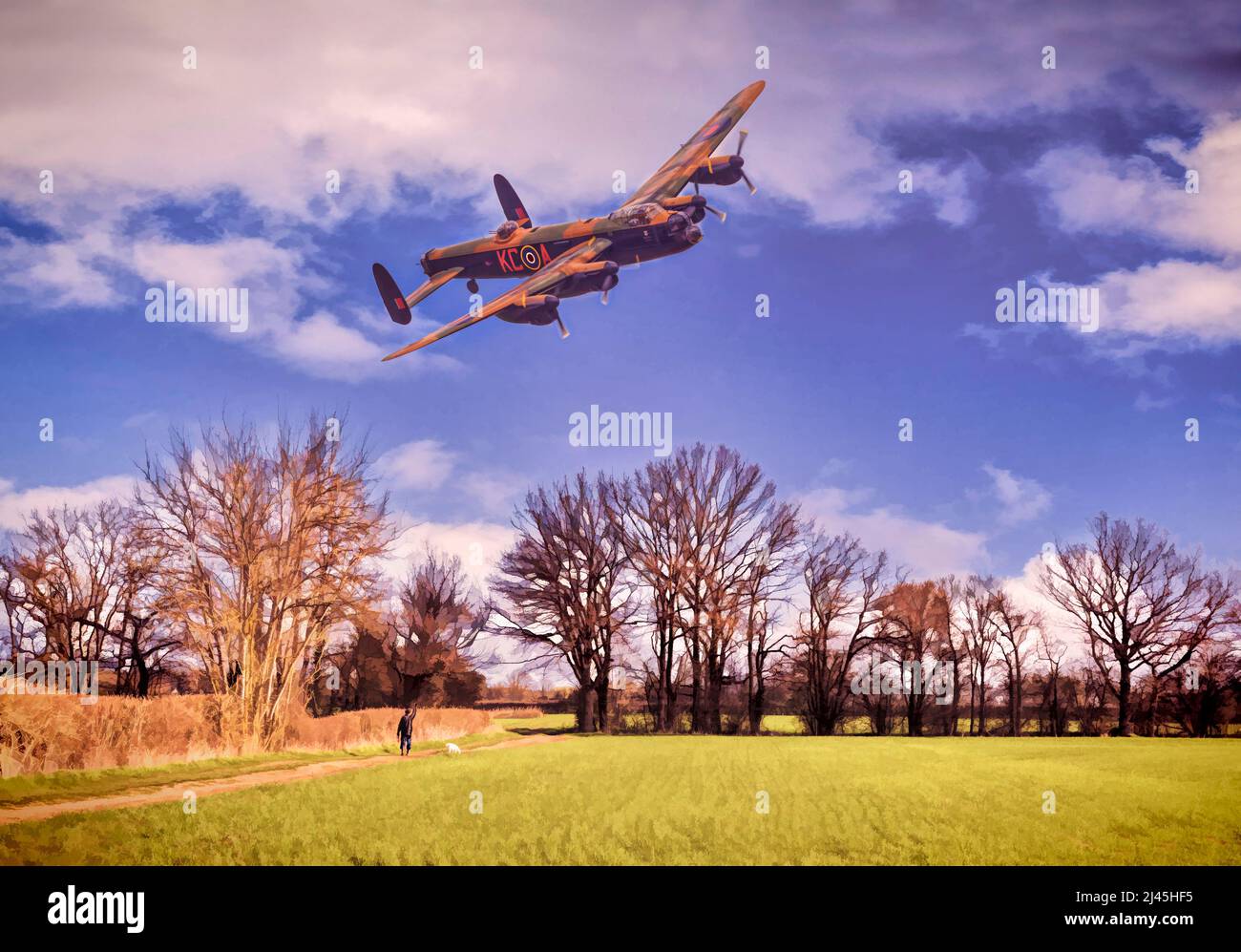 Avro Lancaster flying low over the British countryside with man walking ...
