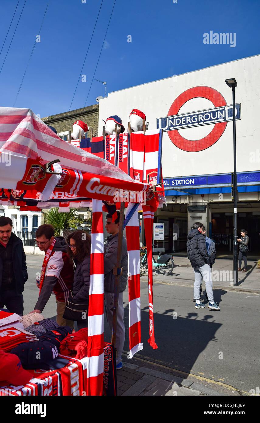 Arsenal tube station with stall selling football scarves in foreground ...