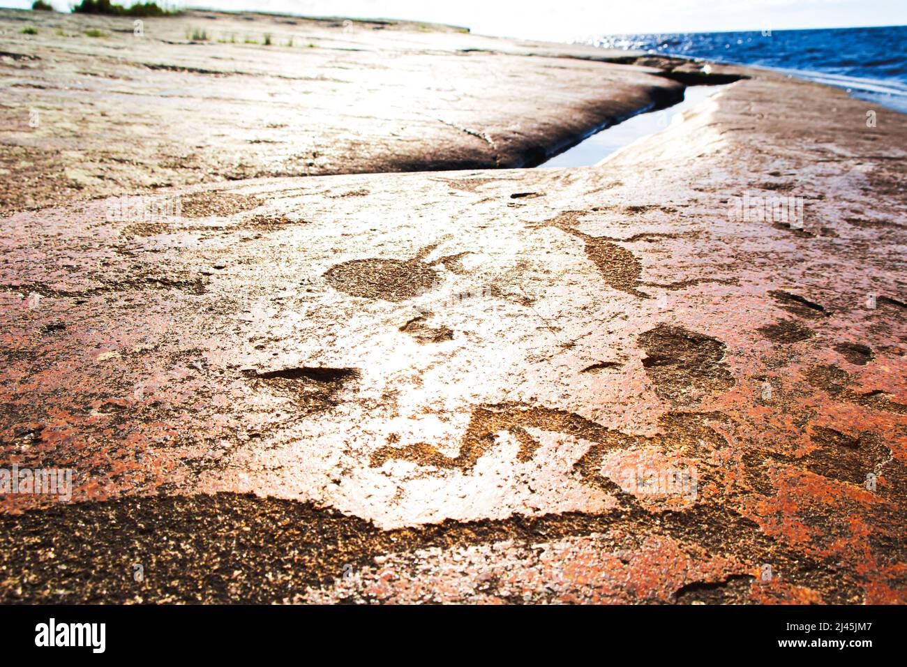 Ancient petroglyphs on the shores of Lake Onega. Carved on a granite ...