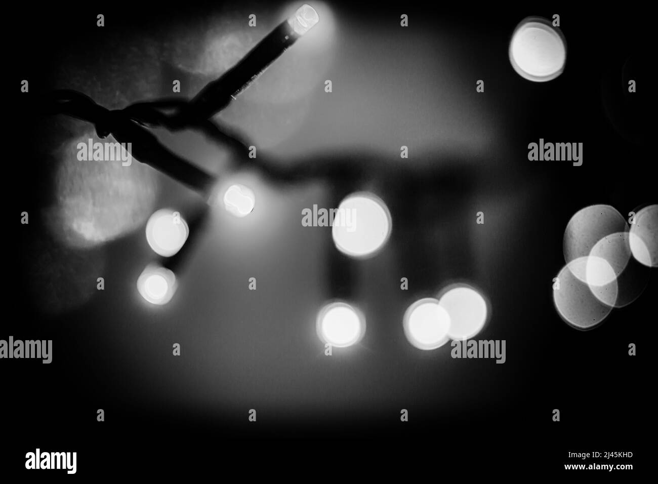 small blurry Christmas lights glowing in the dark Stock Photo - Alamy