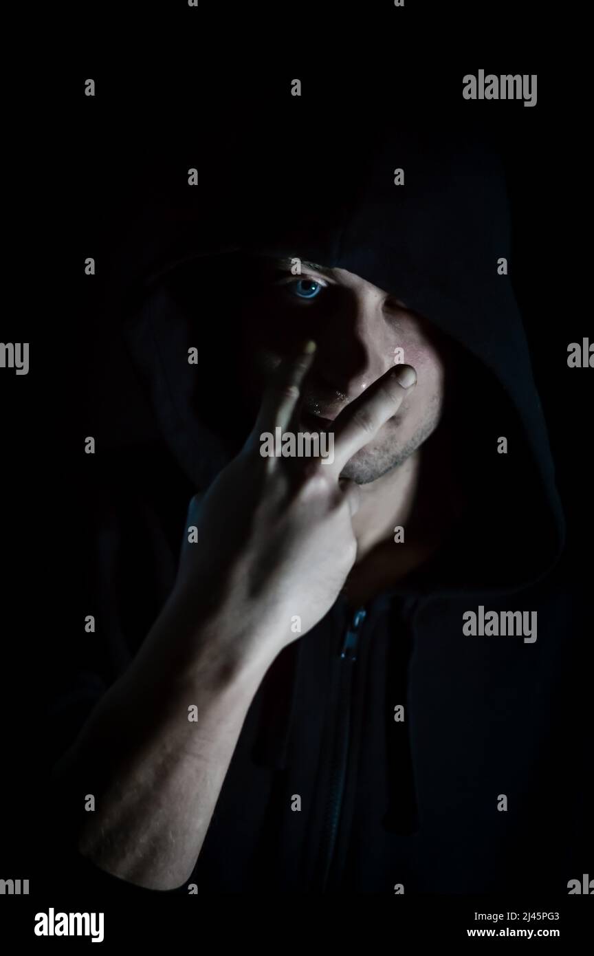I am looking at you - young hooded man making a gesture with two ...