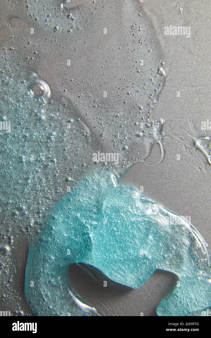Blue cream liquid gel serum on silver texture, makeup and cosmetics ...