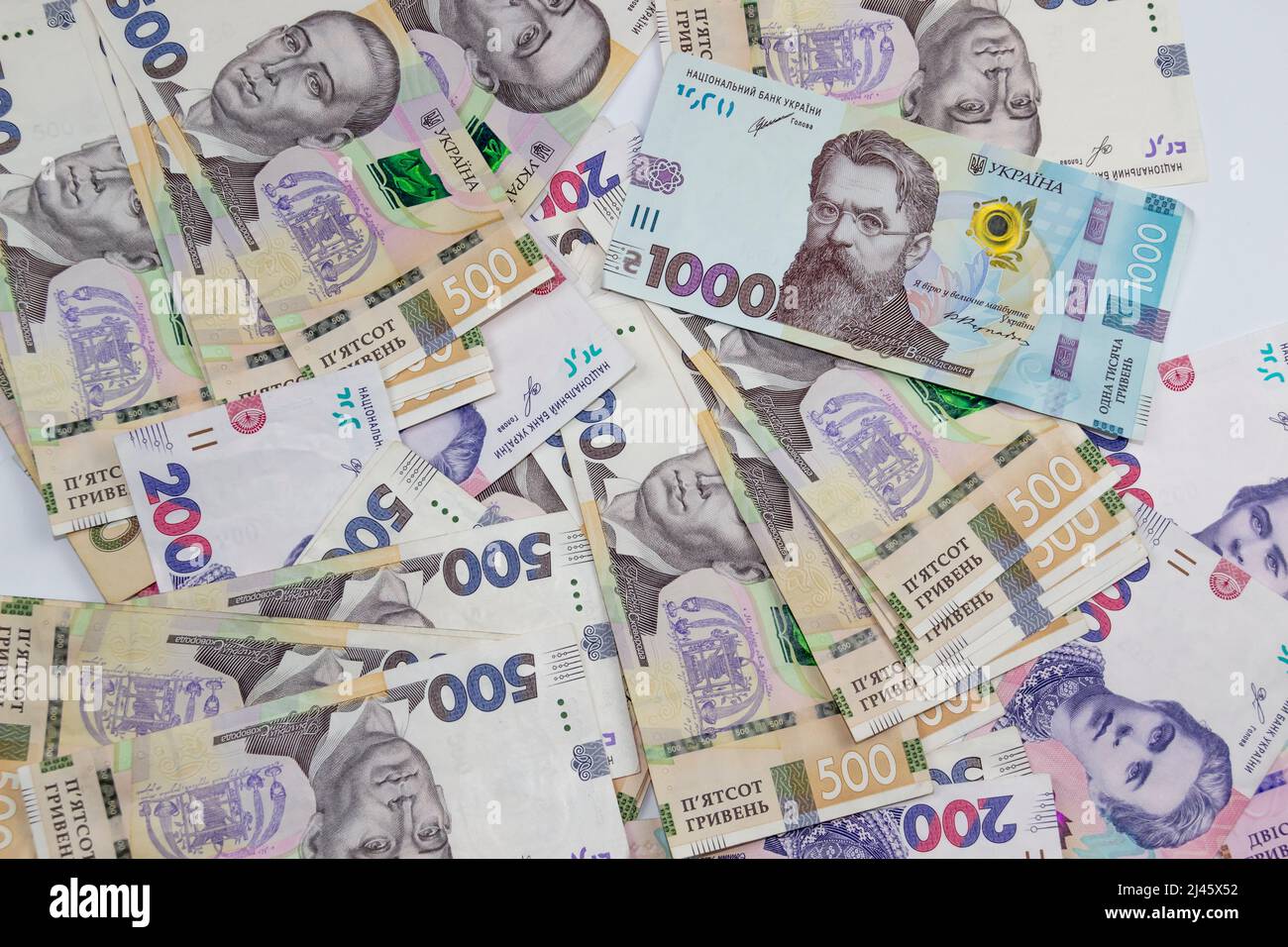 Ukrainian money currency of different denominations scattered. Hryvnia ...