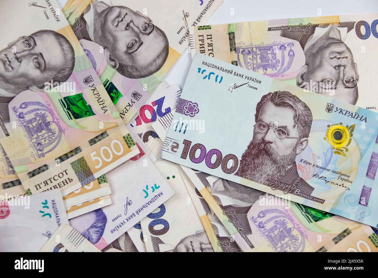 Ukrainian money currency of different denominations scattered. Hryvnia ...