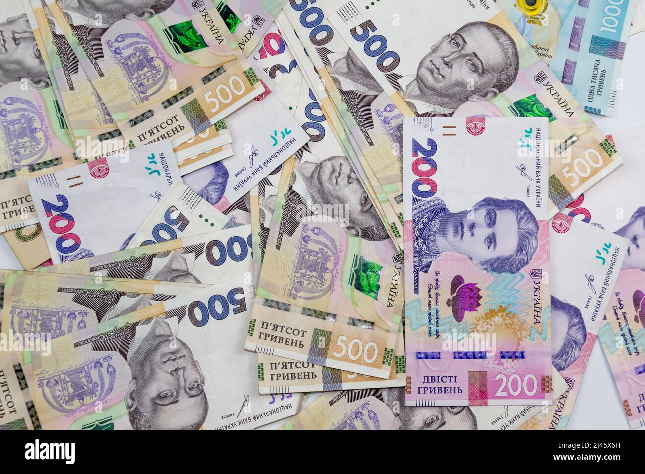 Ukrainian money currency of different denominations scattered. Hryvnia ...