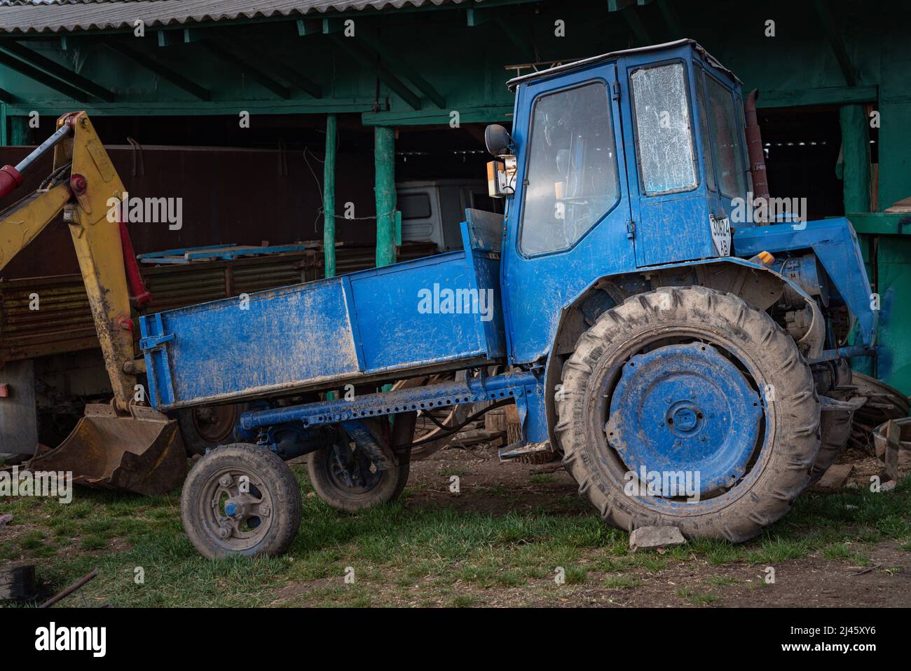 Small blue tractor are ready to hard work in small Ukrainian village ...