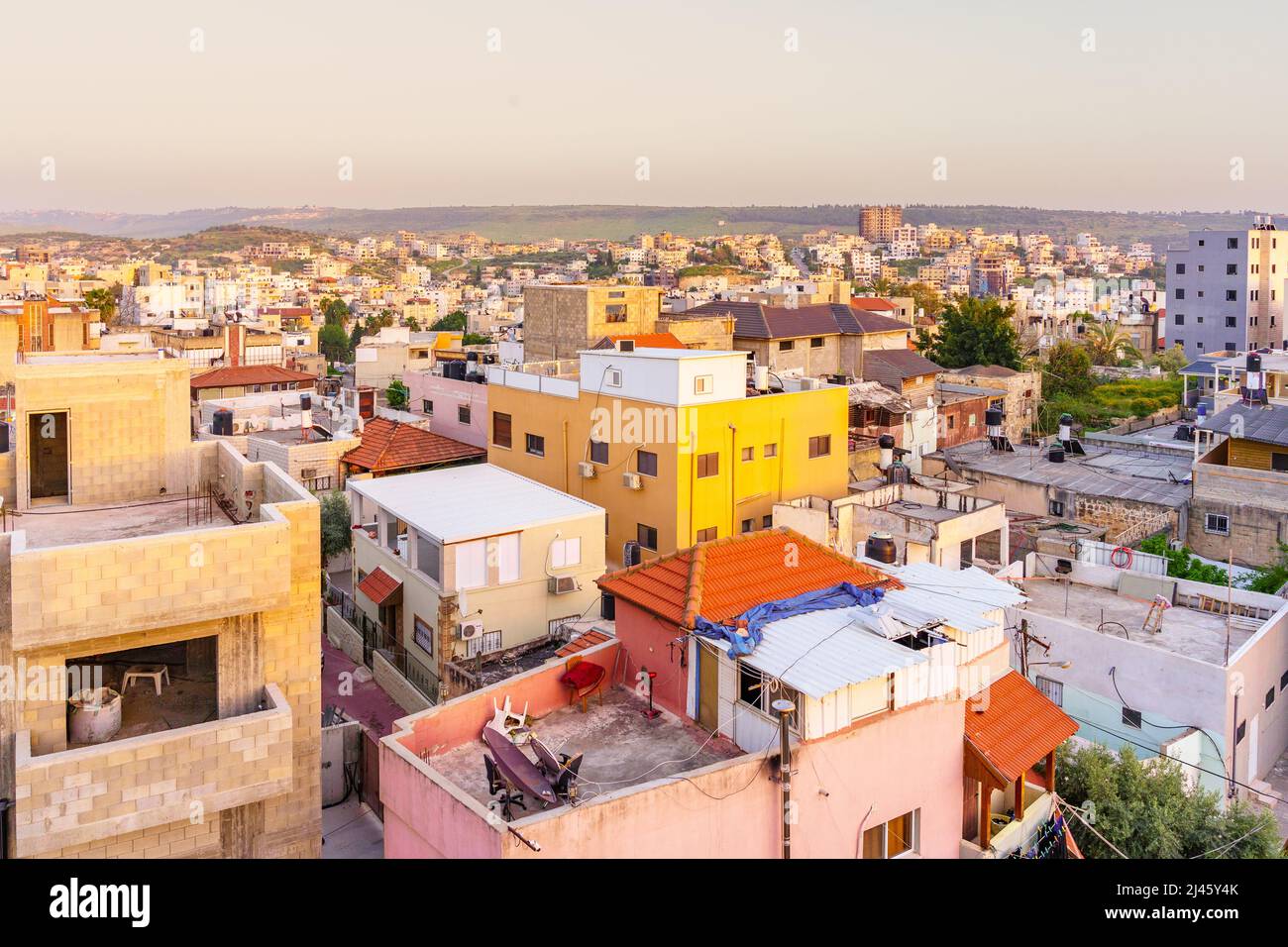 Sunset rooftop view of the center of Tayibe, a Muslim Arab town in ...