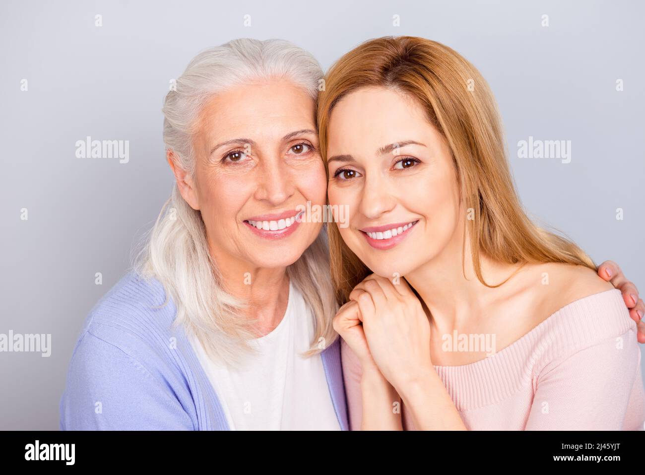 Photo of two cheerful candid people cuddle look camera beaming smile ...