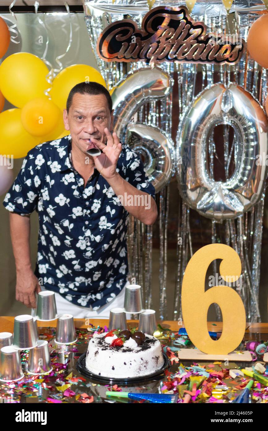 Hispanic Man with number 60 balloons at birthday party Stock Photo - Alamy