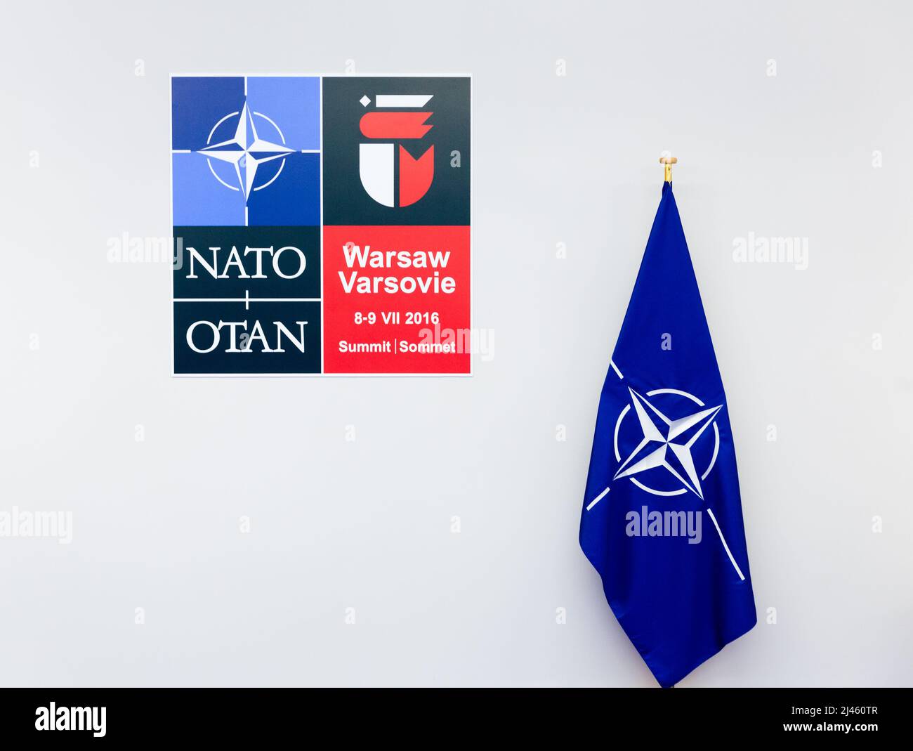 Emblem and a flag of the North Atlantic Treaty Organization (NATO) seen ...