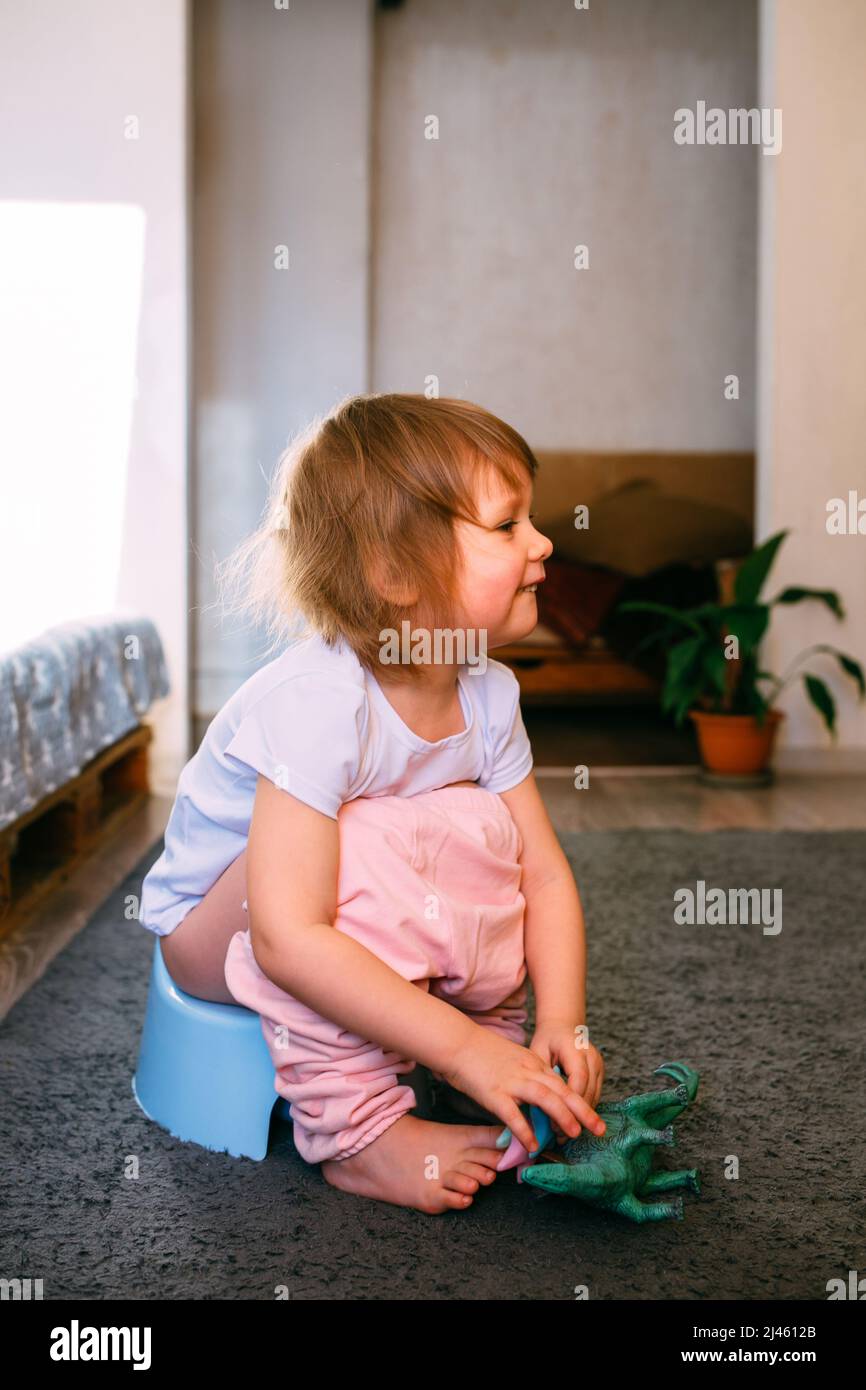 Cute toddler girl, potty training, playing with his toys on potty Stock Photo - Alamy
