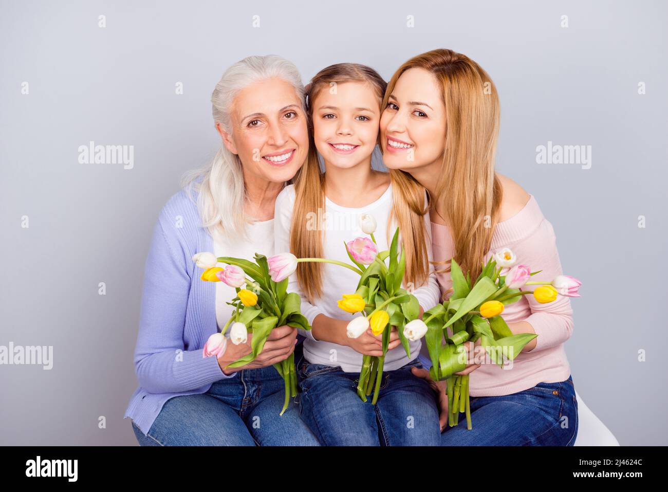 Portrait of three idyllic positive people sitting embrace hold fresh ...