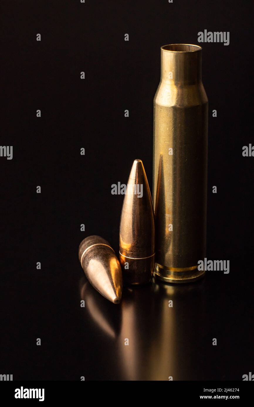 Bullet isolated on black background with reflexion. Rifle bullets close ...